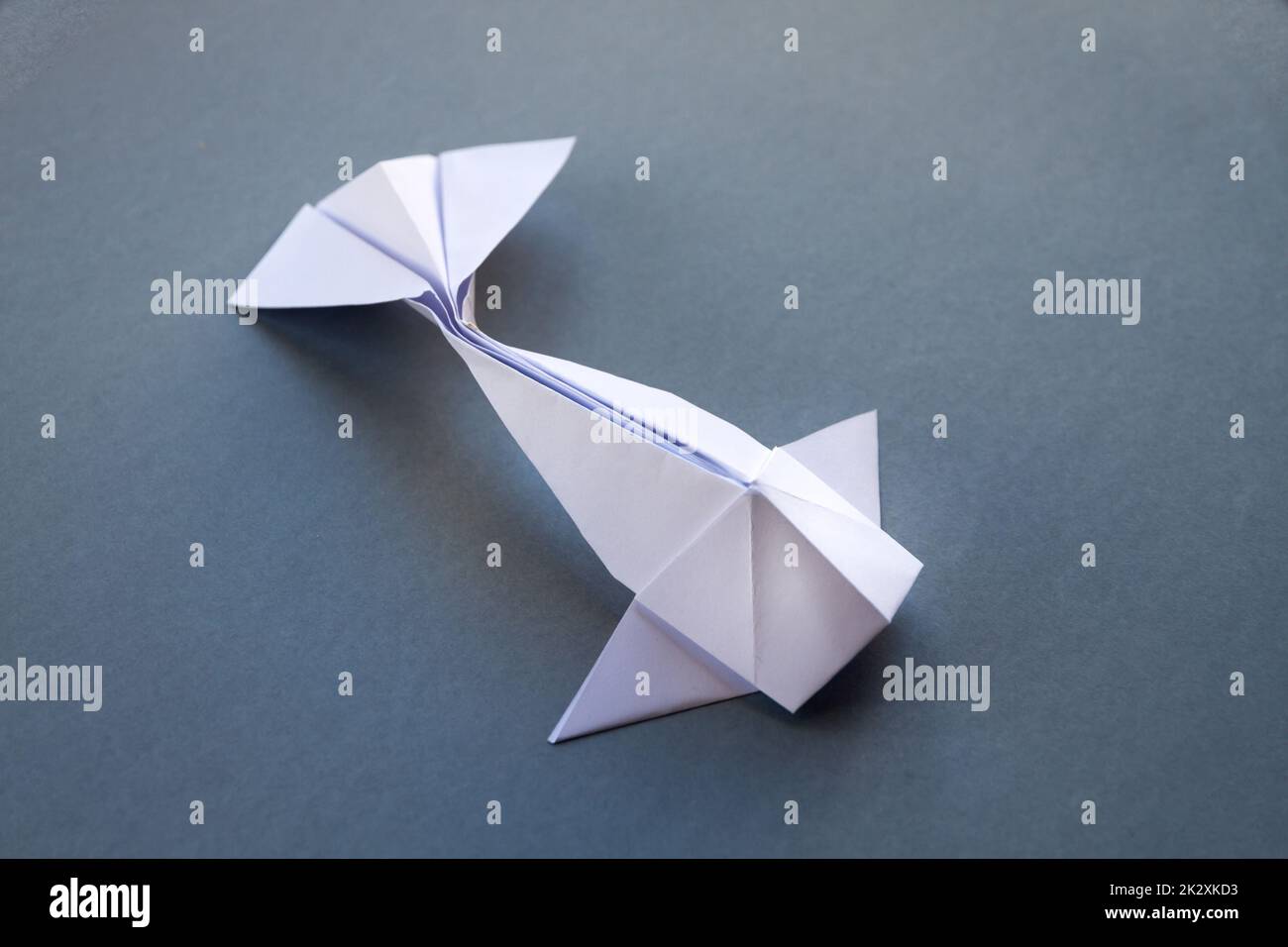 White paper fish origami isolated on a grey background Stock Photo - Alamy