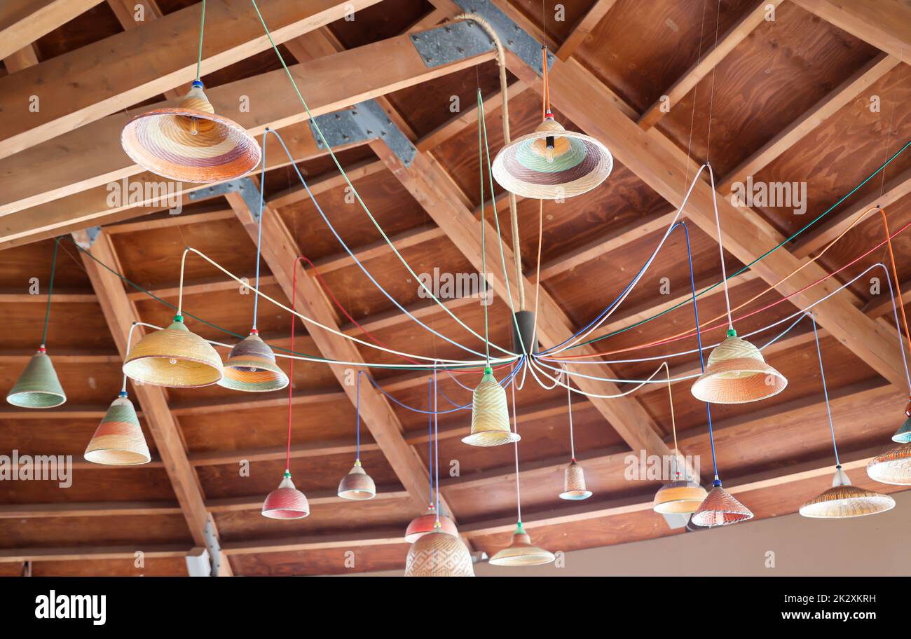On a ceiling hang many lampshades with long cables Stock Photo - Alamy