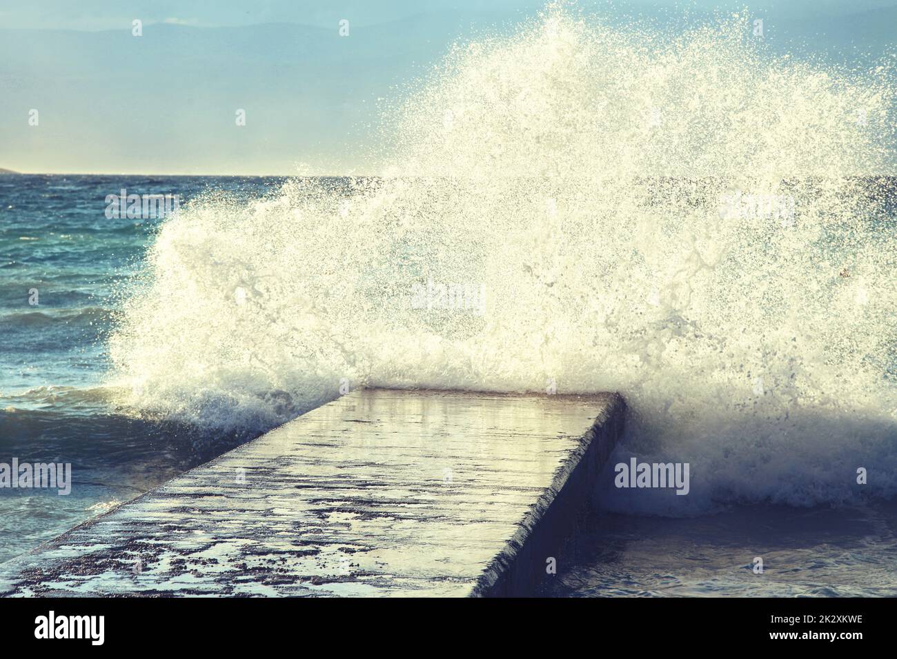 Big waves crushing on stone pier, on stormy weather Stock Photo - Alamy