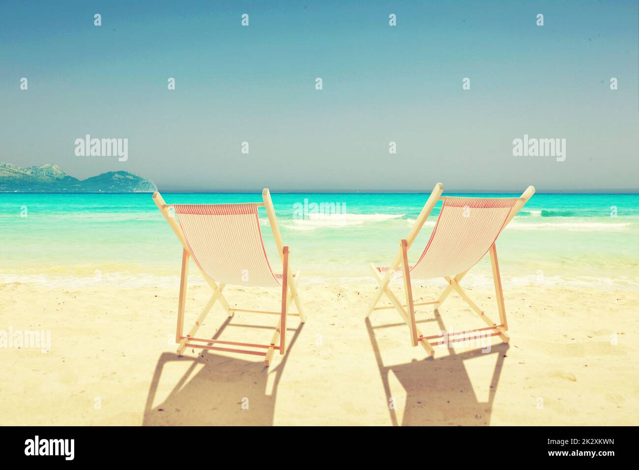Relax on tropical beach in the sun on deck chairs Stock Photo - Alamy