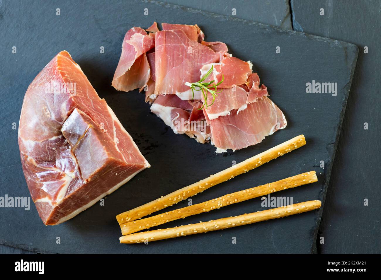 Italian ham served with grissini Stock Photo - Alamy