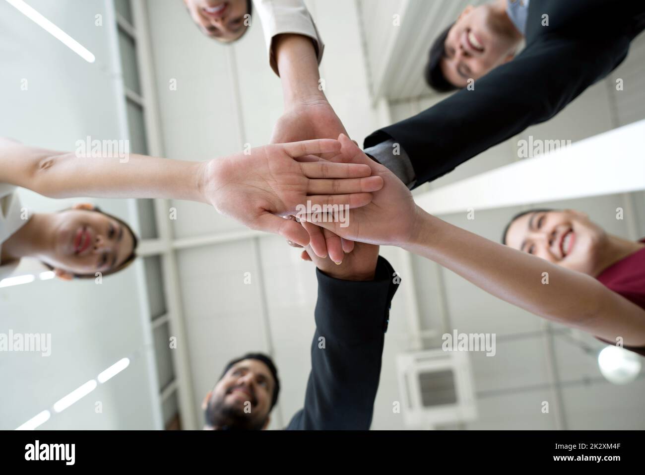 Team building concept. Coworkers standing in circle holding hands ...