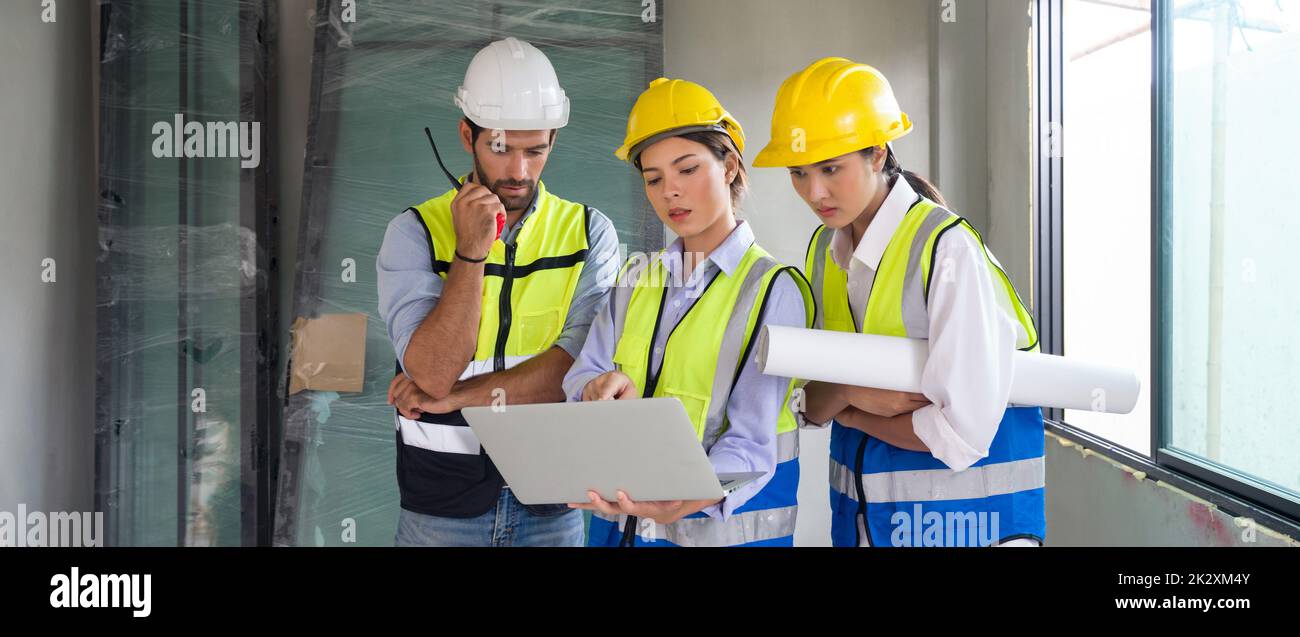 Young architect pointing at laptop computer monitor explain to foreman ...