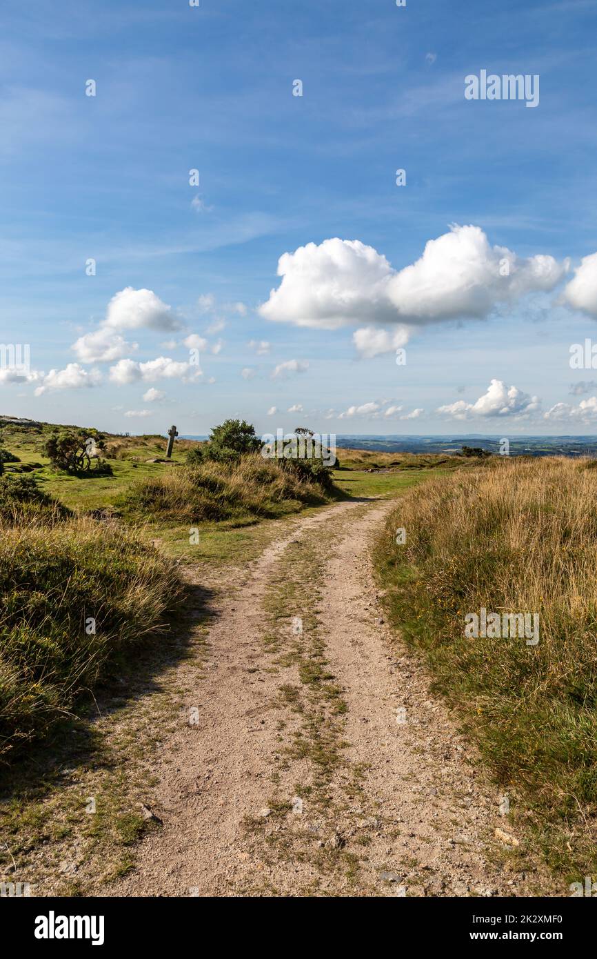 A pathway in Dartmoor on a sunny Septemer day, with Windy Post stone ...