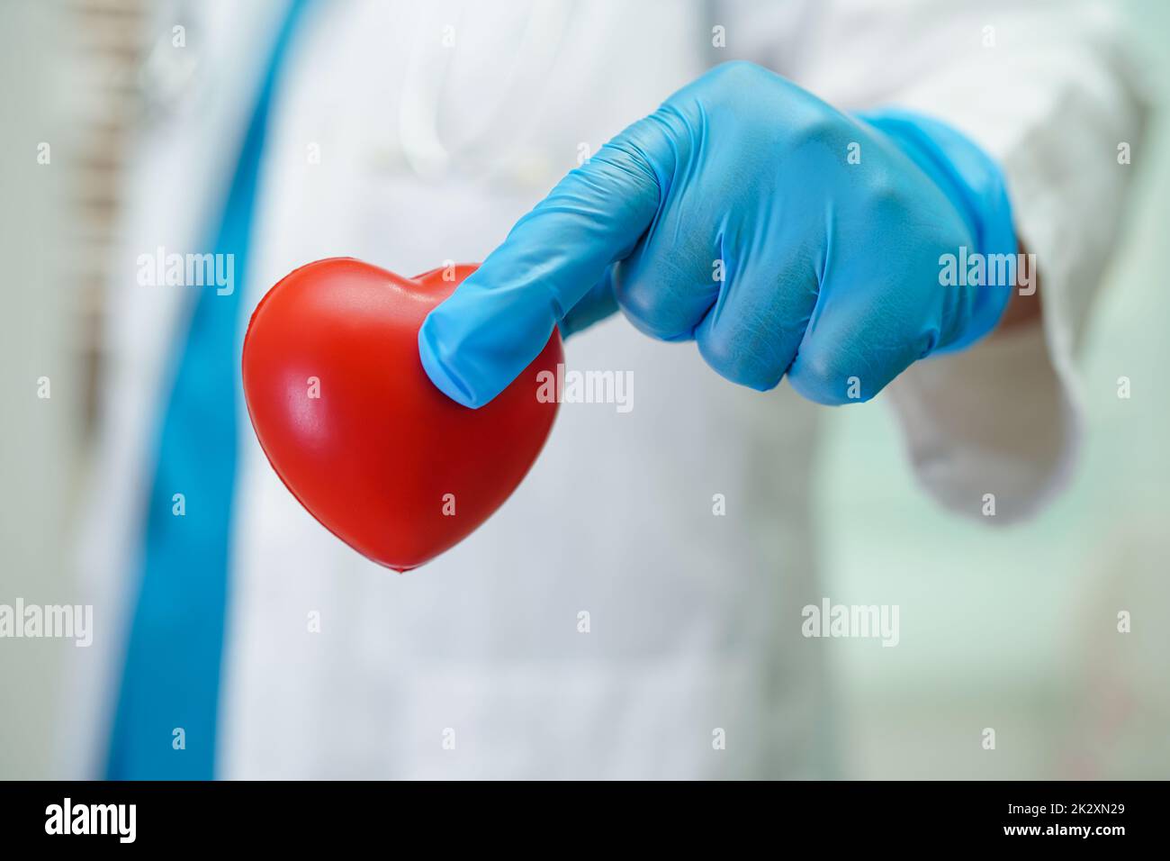 Asian woman doctor holding red heart for health in hospital Stock Photo ...