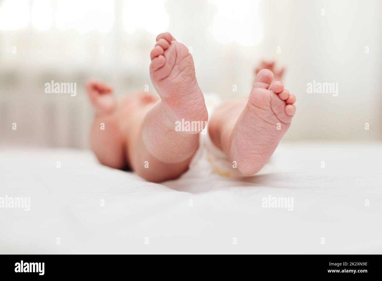 Cute boy bed feet hi-res stock photography and images - Alamy