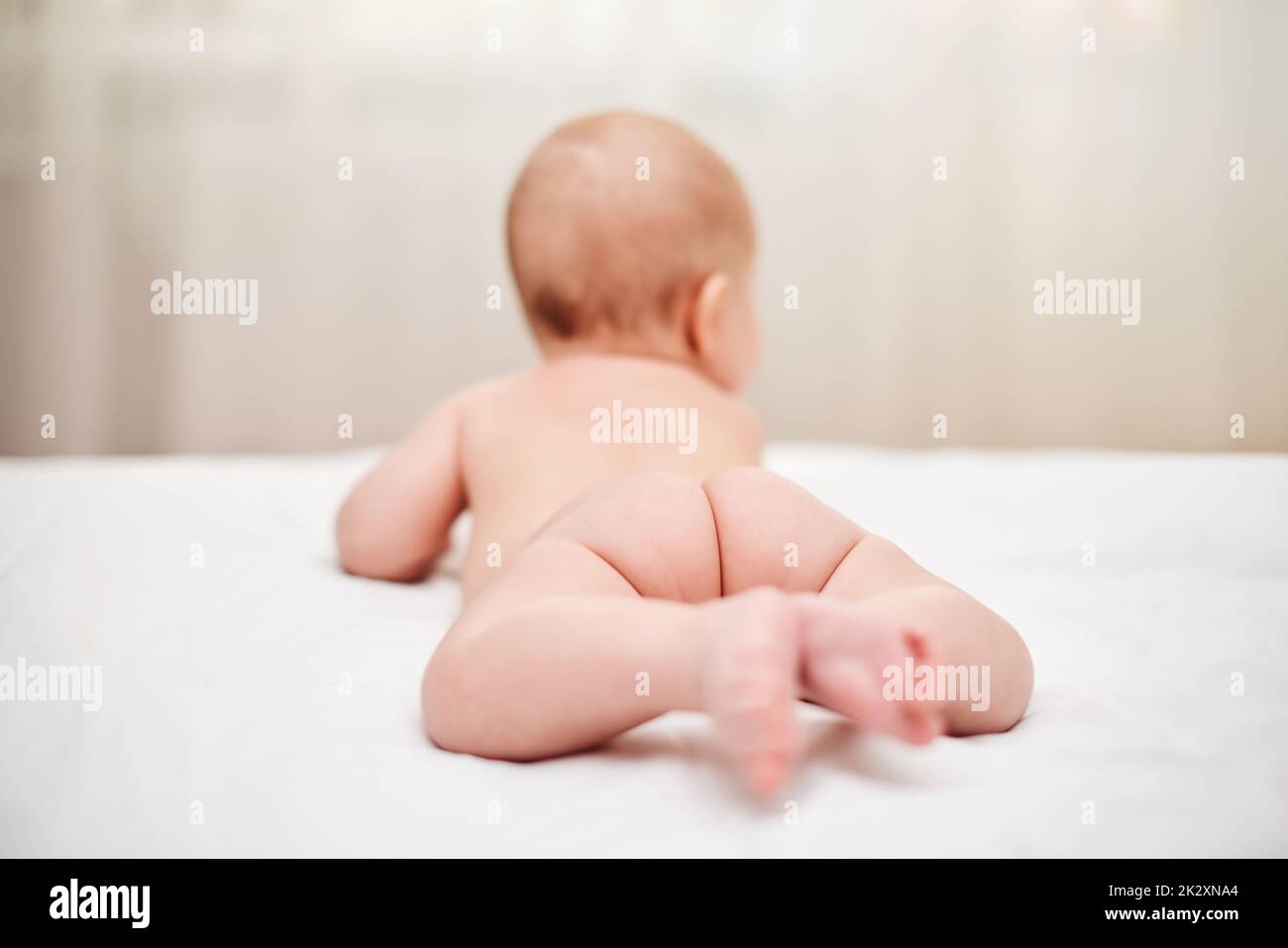 Cute little baby in diaper on bed Stock Photo - Alamy