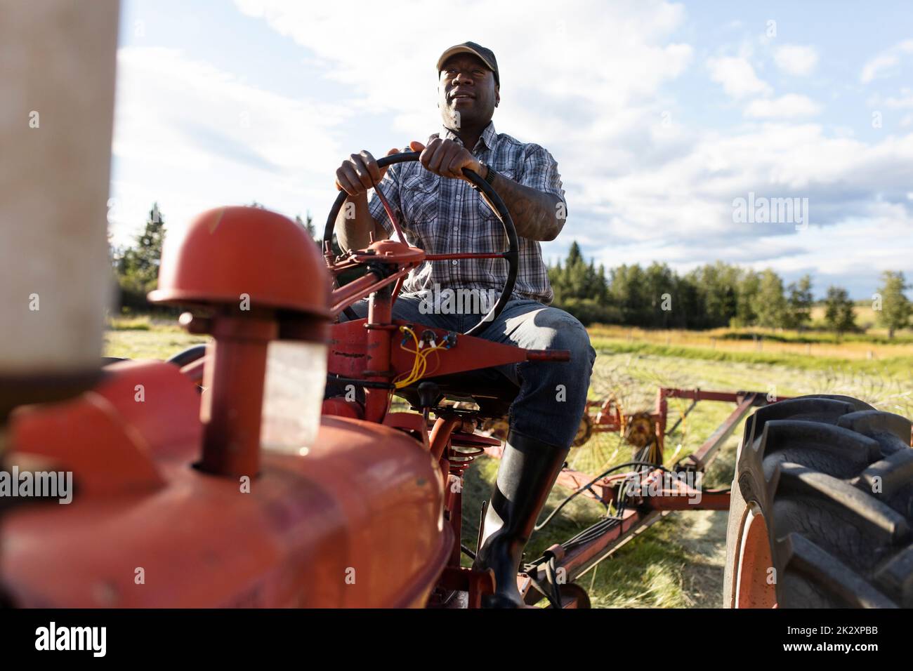 Black man driving tractor hi-res stock photography and images - Alamy