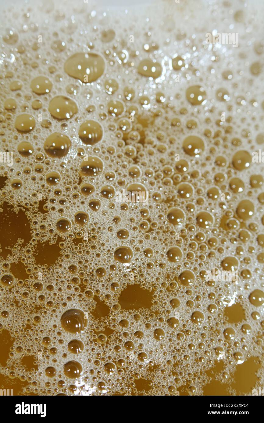 Different size of water bubbles close up modern yellow background high ...