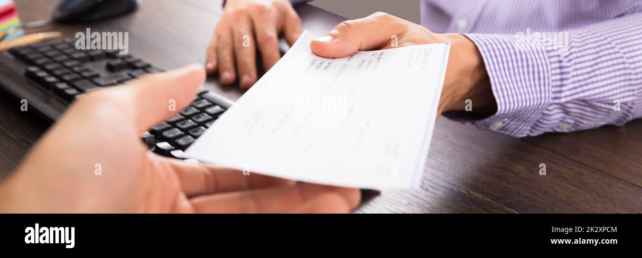 Businessman Giving Cheque To Her Colleague Stock Photo - Alamy