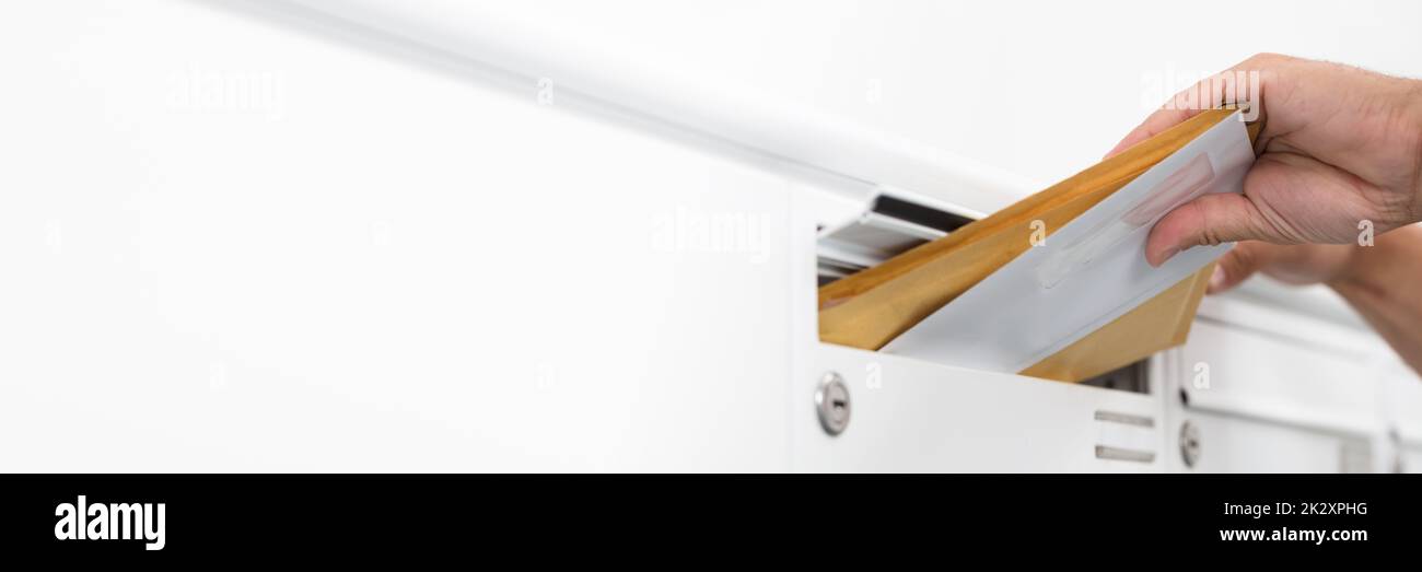Man taking letters from mailbox Stock Photo - Alamy