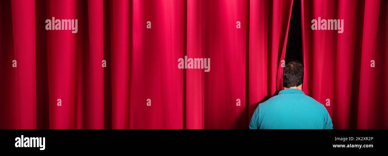 Man Peeking Through A Stage Curtain Stock Photo - Alamy