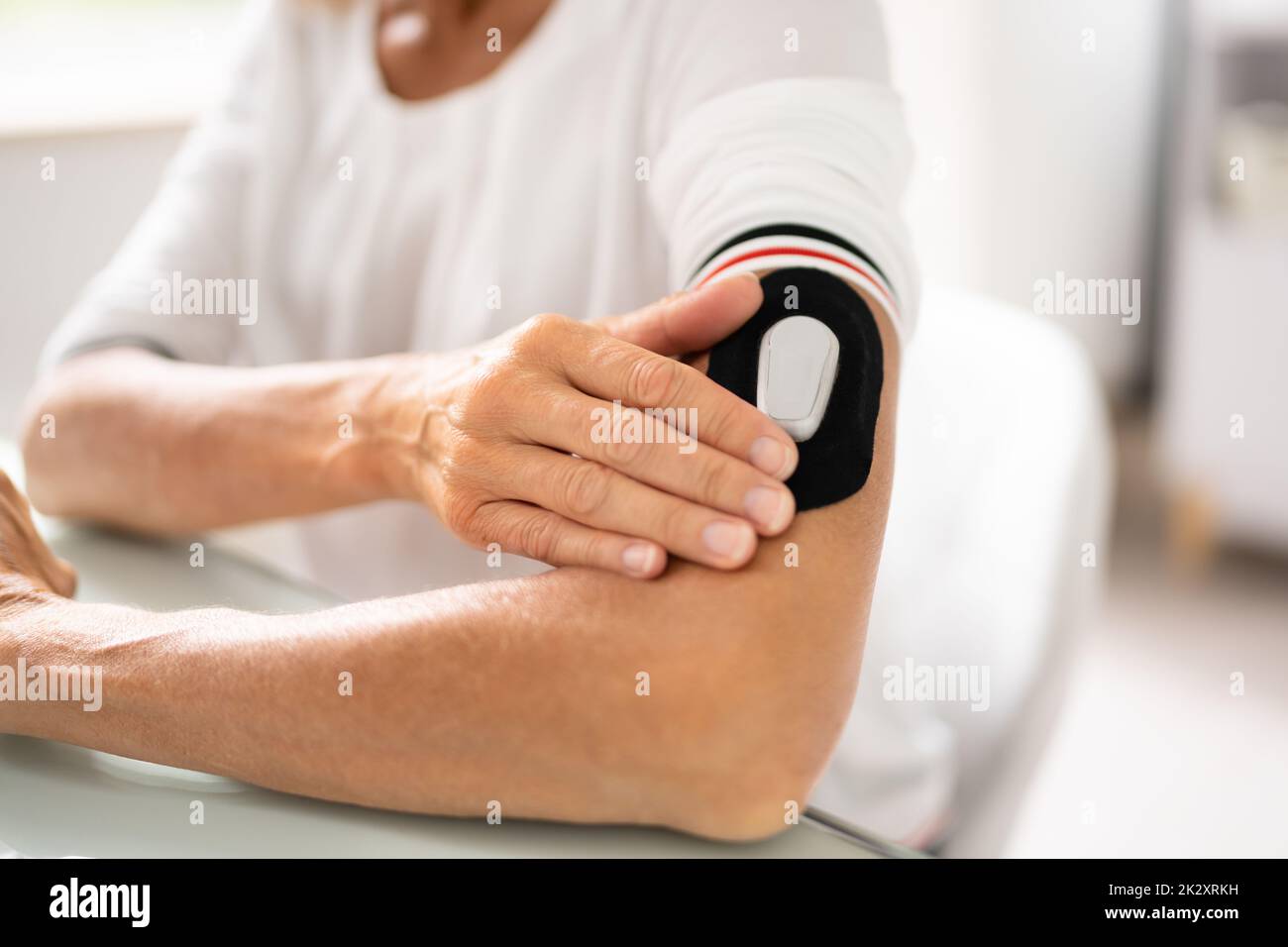 Woman Testing Glucose Level With A Continuous Glucose Monitor Stock ...