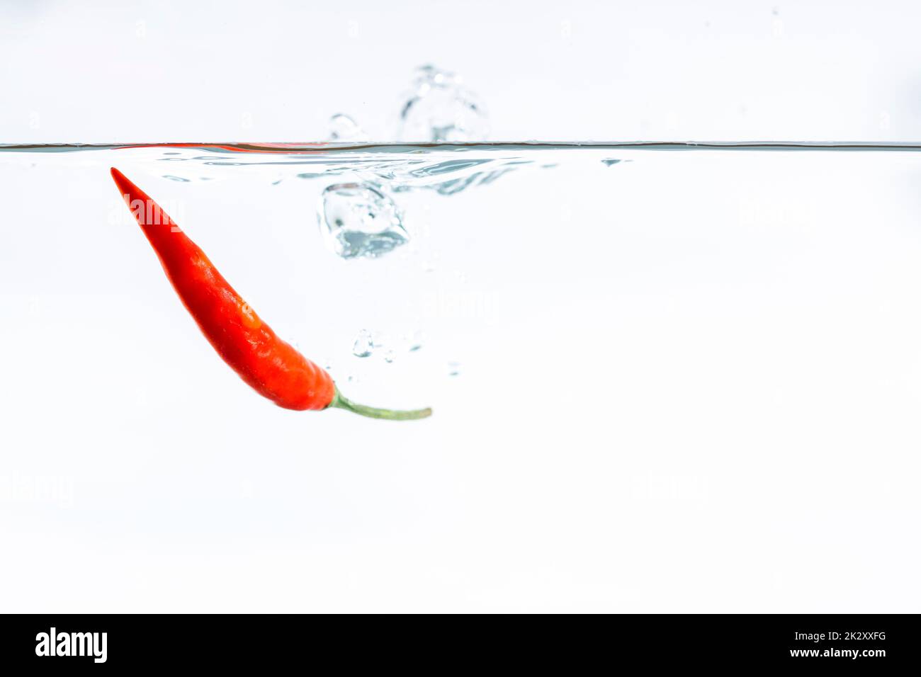 Red chilli, water splashes, solated on a white background Stock Photo ...
