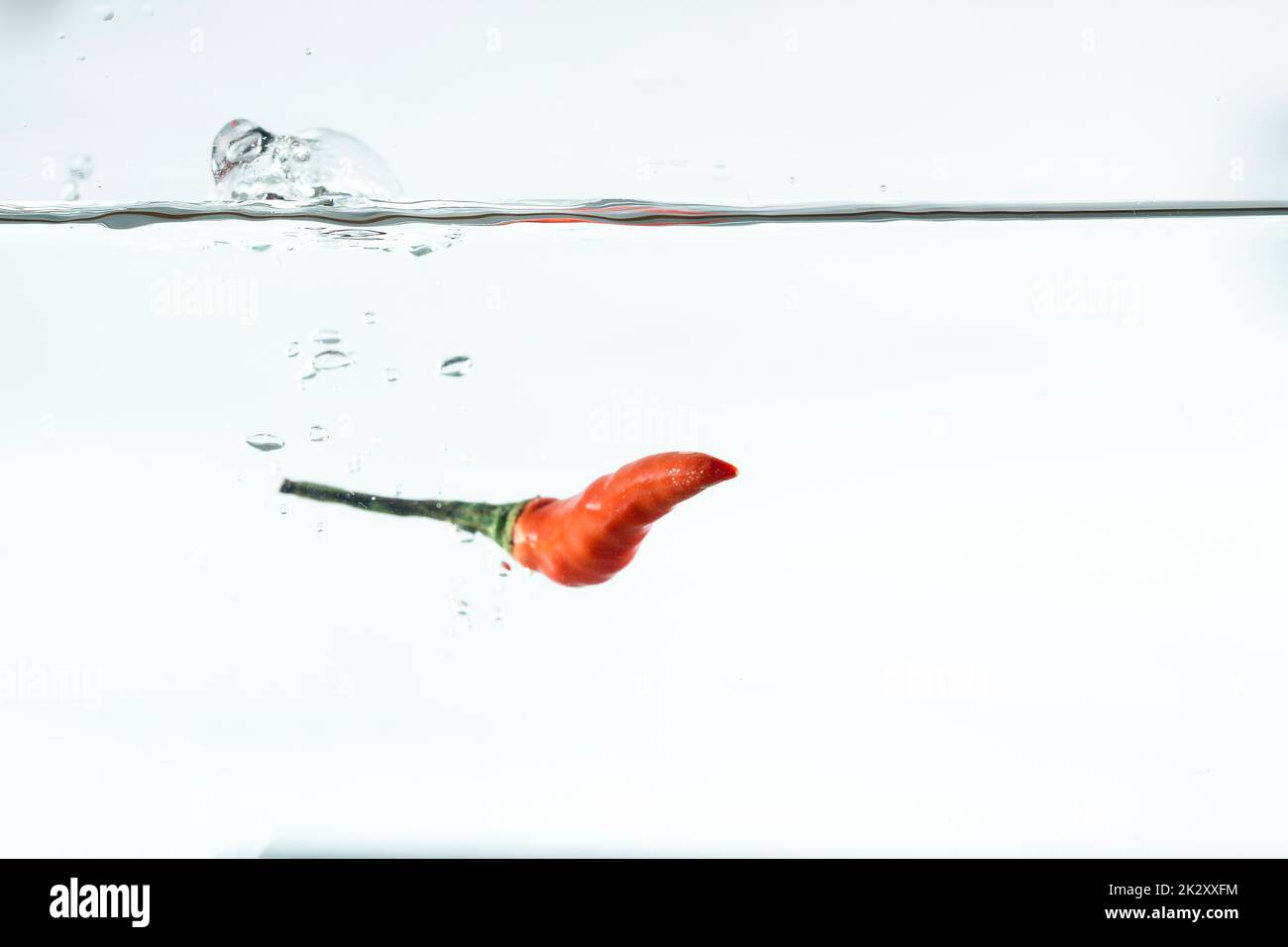 Red chilli, water splashes, solated on a white background Stock Photo ...