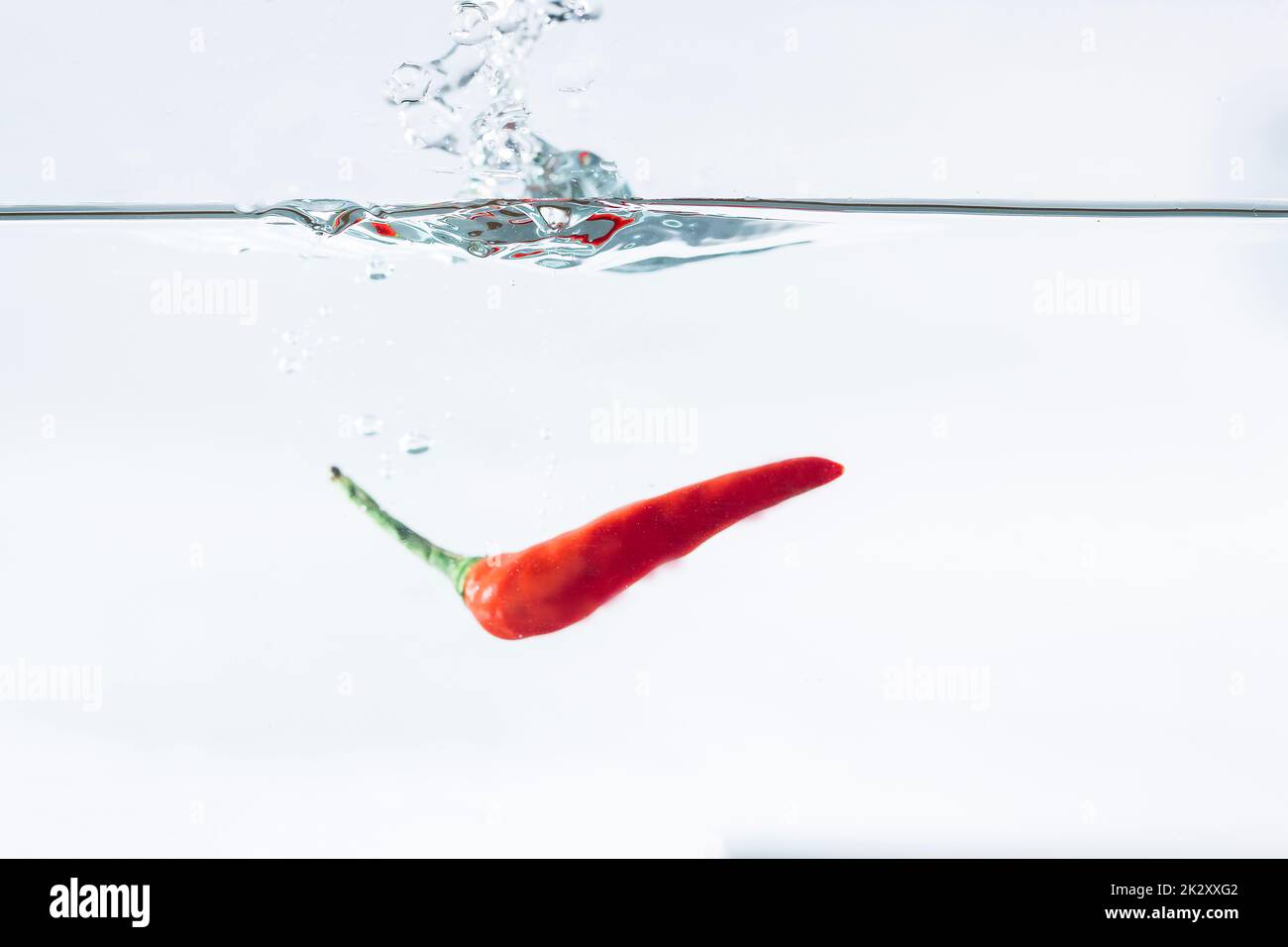 Red chilli, water splashes, solated on a white background Stock Photo ...