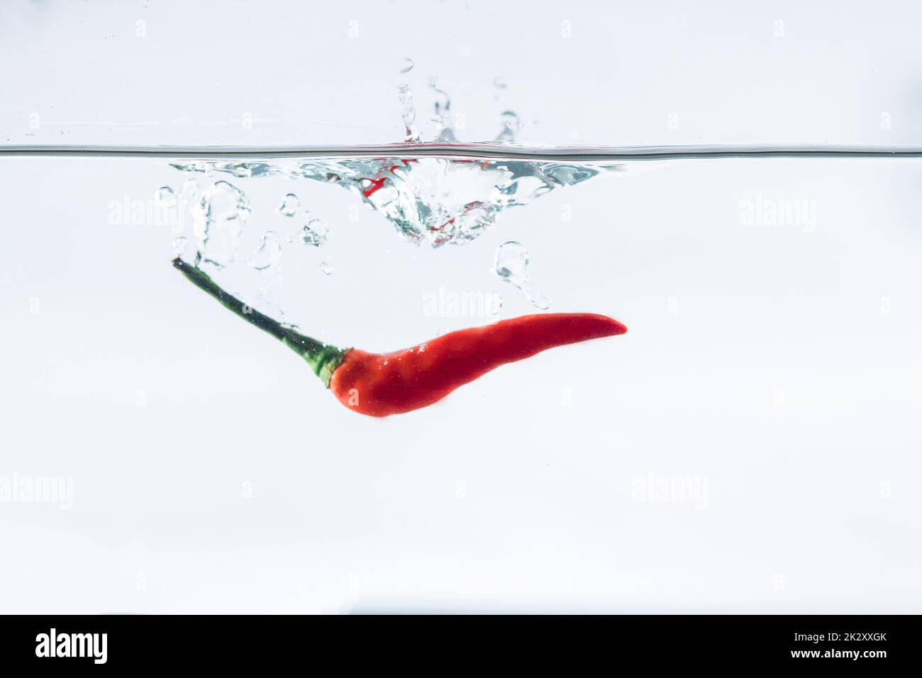 Red chilli, water splashes, solated on a white background Stock Photo ...