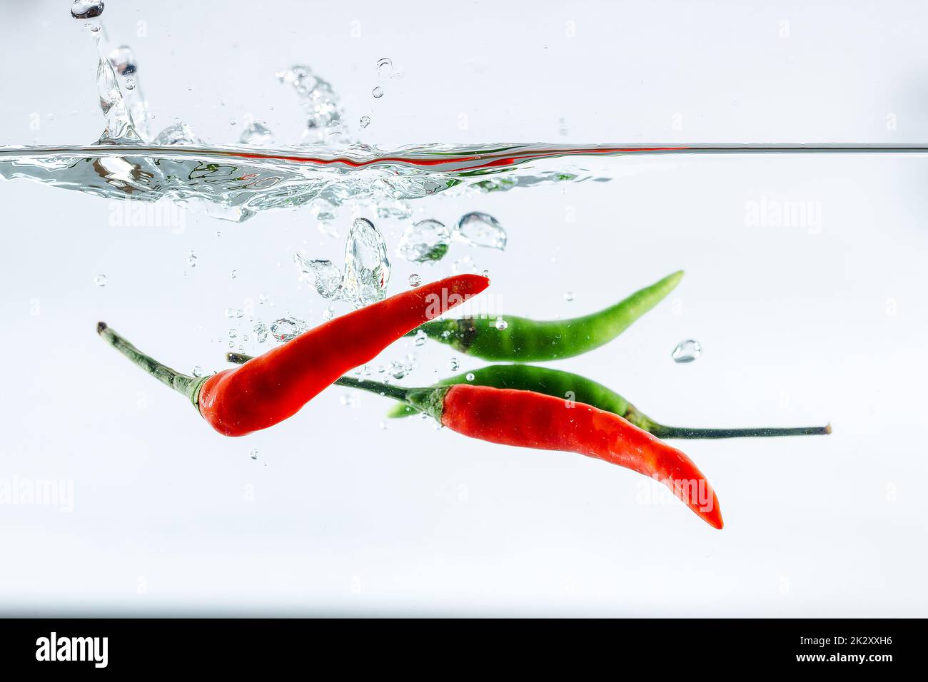 Red chilli, water splashes, solated on a white background Stock Photo ...
