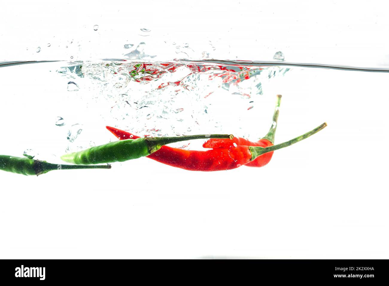 Red chilli, water splashes, solated on a white background Stock Photo ...
