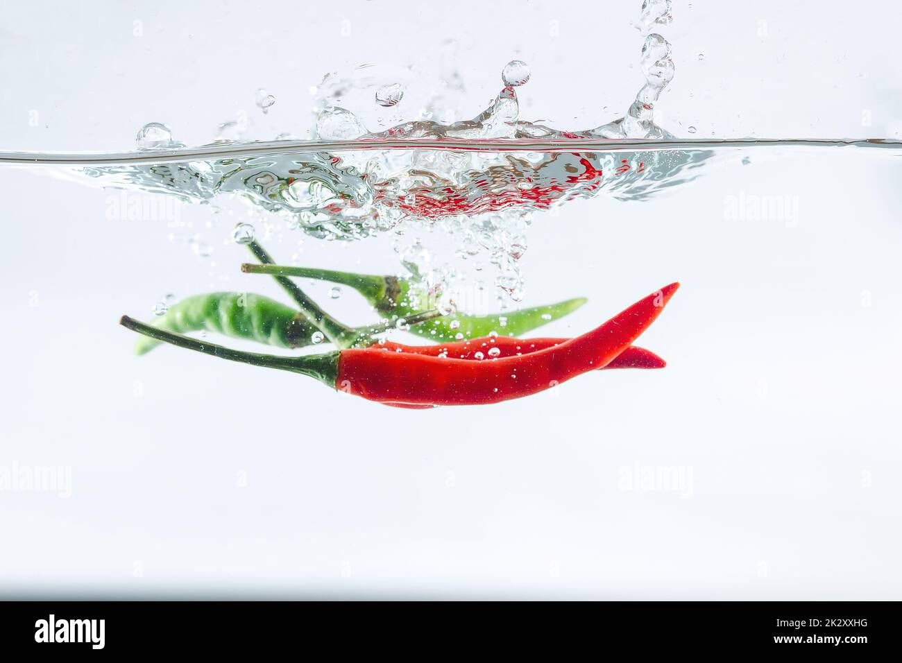 Red chilli, water splashes, solated on a white background Stock Photo ...