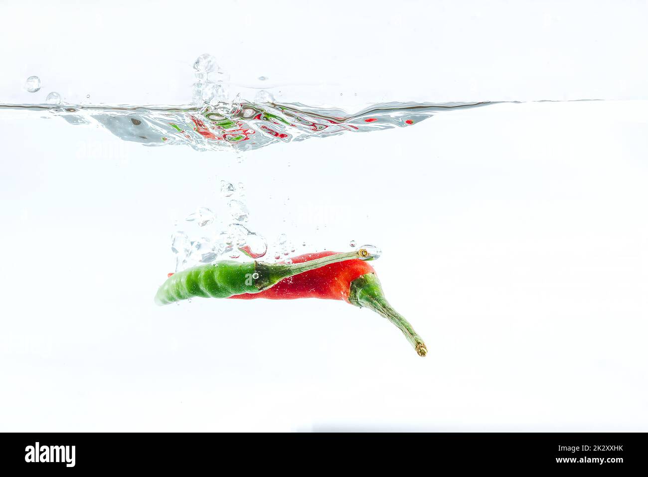 Red chilli, water splashes, solated on a white background Stock Photo ...