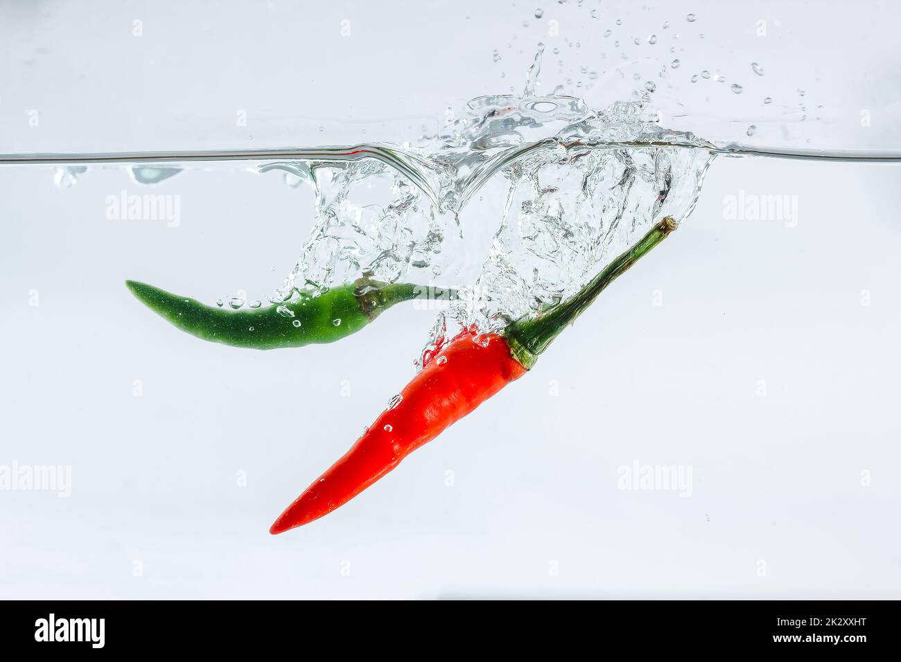 Red chilli, water splashes, solated on a white background Stock Photo ...
