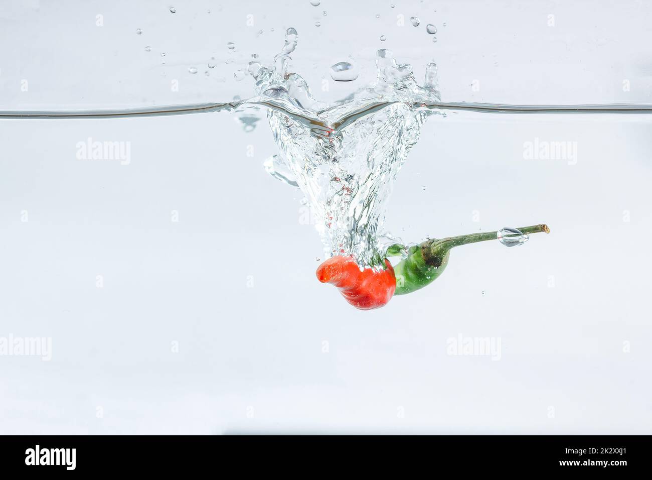 Red chilli, water splashes, solated on a white background Stock Photo ...
