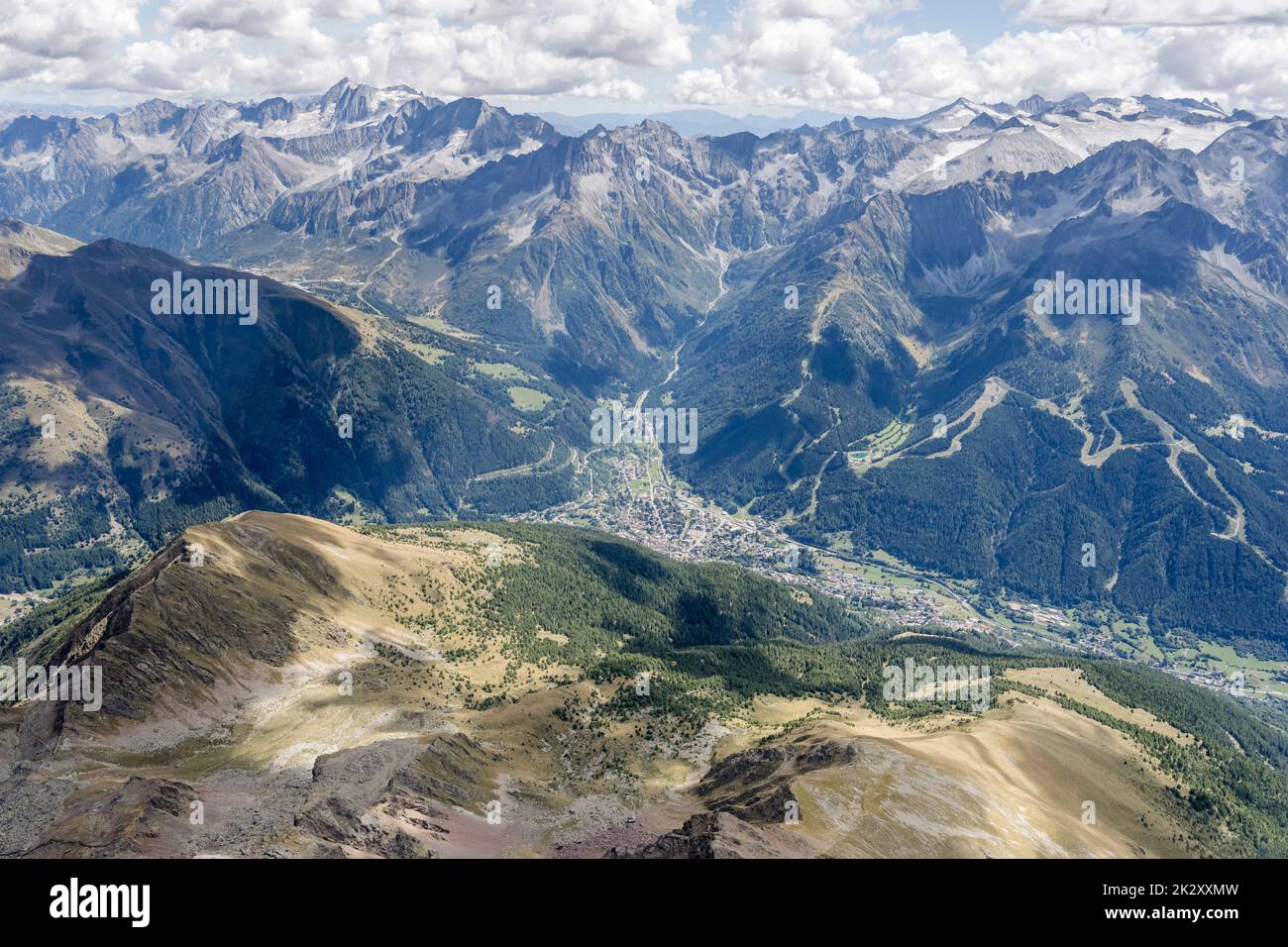 aerial shot, from a glider, of Ponte di Lagno village with Adamello ...