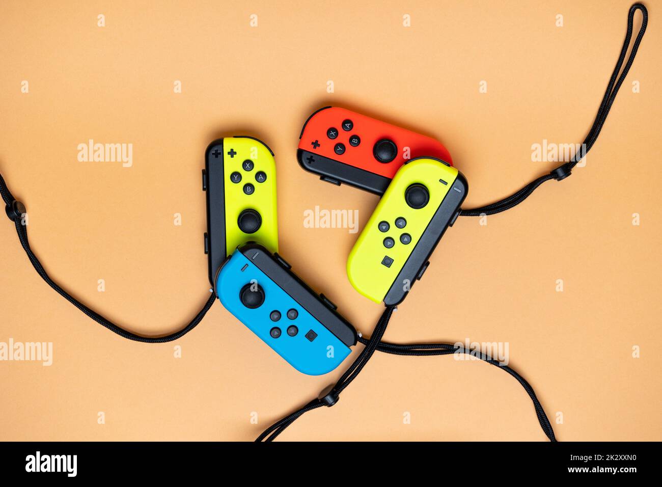 The top view of the pairs of colorful Nintendo Joycons over the orange ...