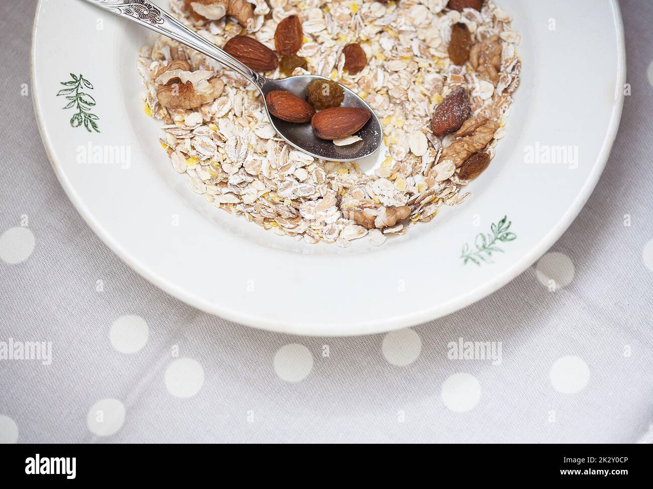 Oatmeal bowl with nuts, useful food Stock Photo - Alamy