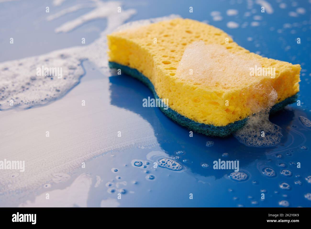 Cleaning sponge with white foam Stock Photo - Alamy