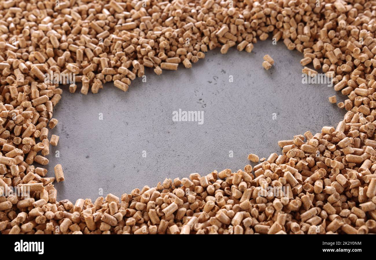 Heap of fuel pellets scattered on gray table Stock Photo - Alamy