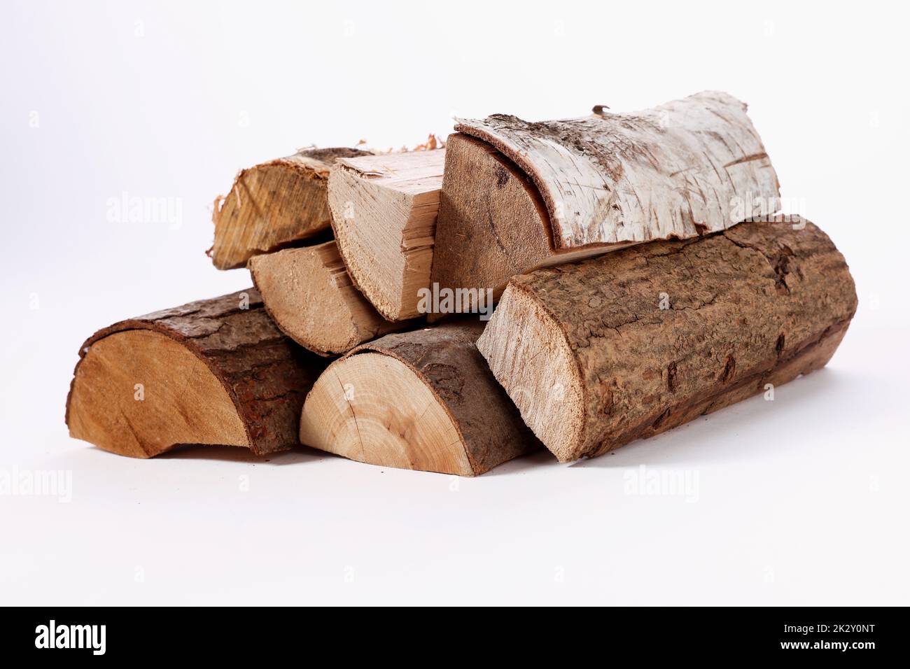 Stack of cut assorted tree trunks on white surface Stock Photo - Alamy