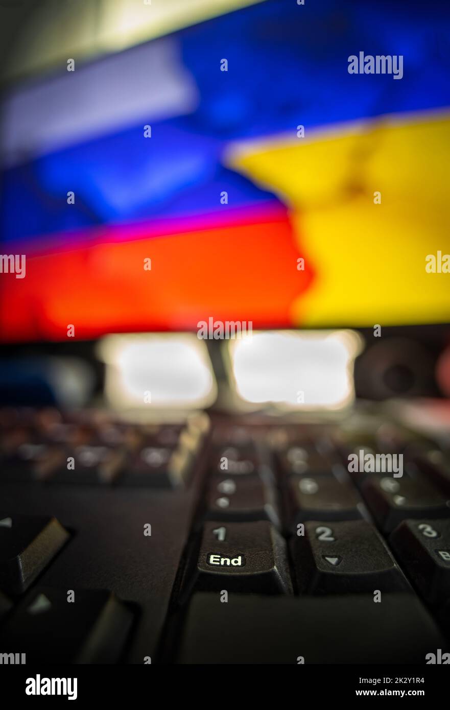 A selective focus of s computer keyboard with a colorful blurry ...