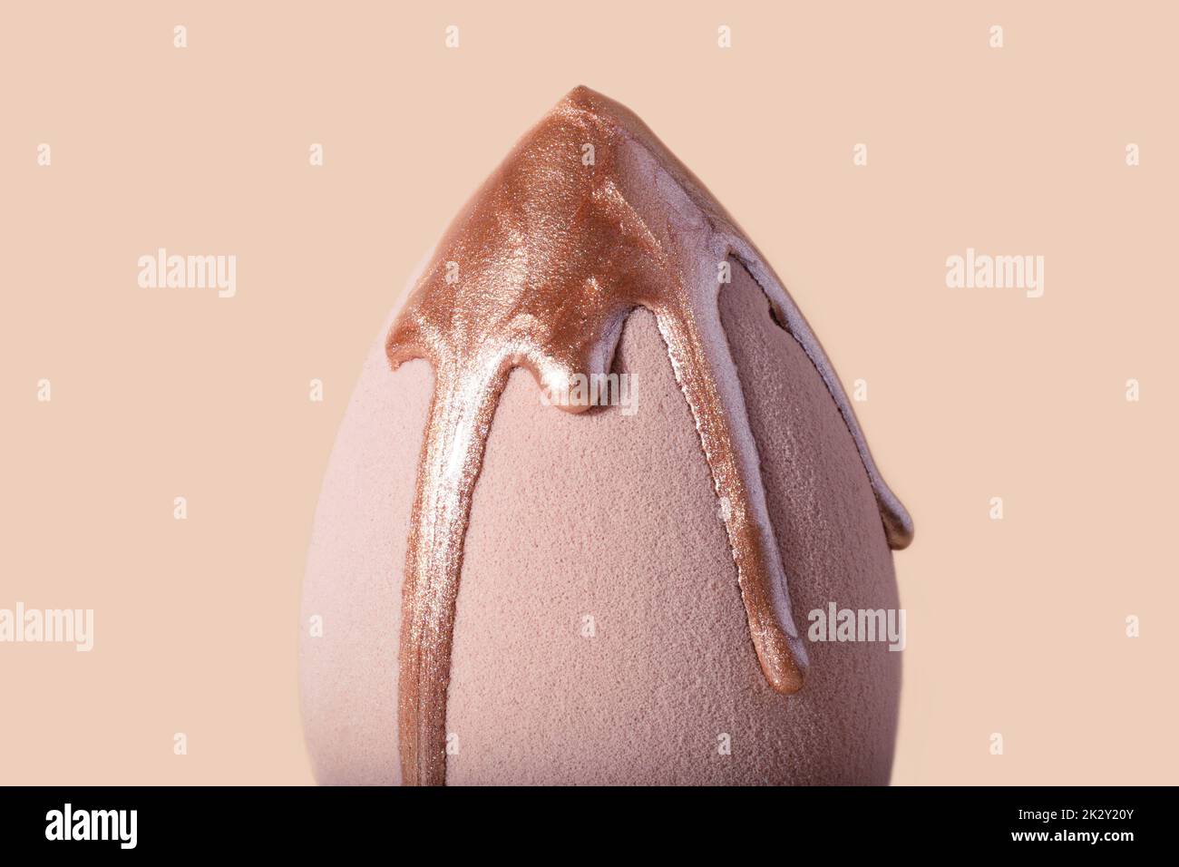Closeup photography of beauty blender with dripping bronzer on it ...
