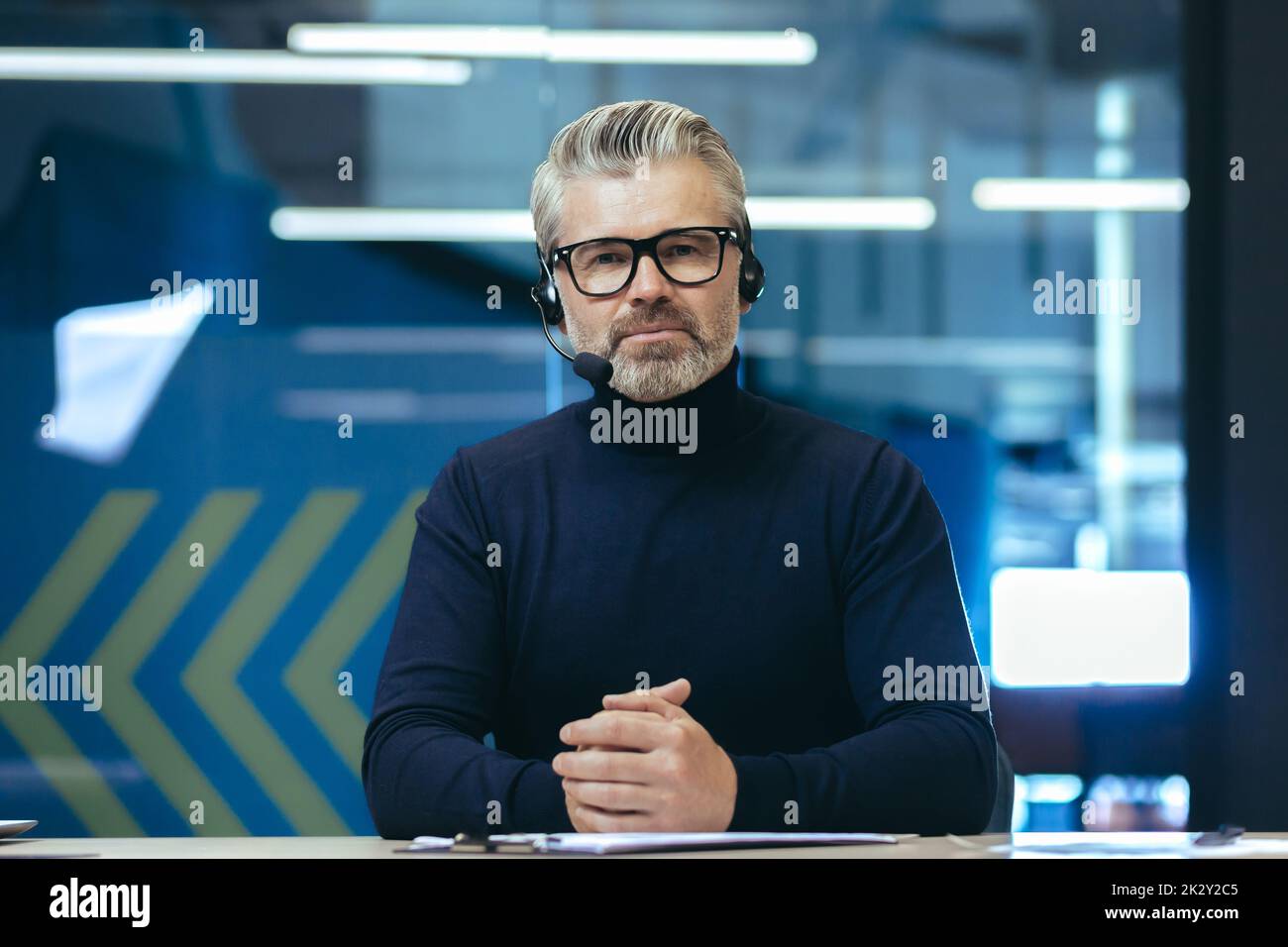 Video call, serious and mature businessman looking thoughtfully at ...