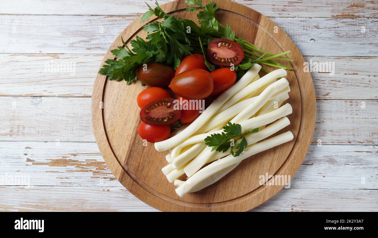 String cheese or cheese whip - salty snack cheese with cherry tomatoes ...