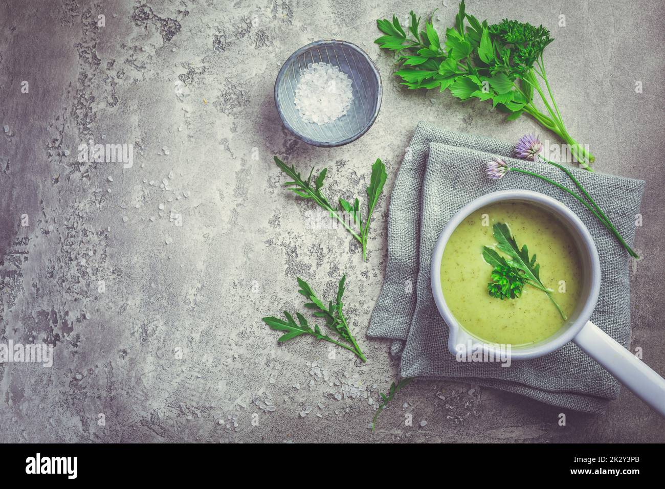 Healthy homemade green herb soup in pot made from local wild and garden ...