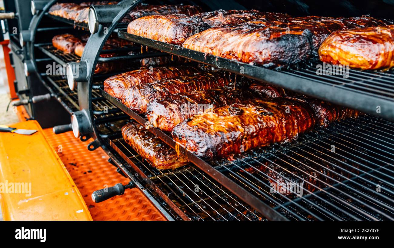 Large barbecue smoker grill with grilled meat wrapped with bacon Stock ...