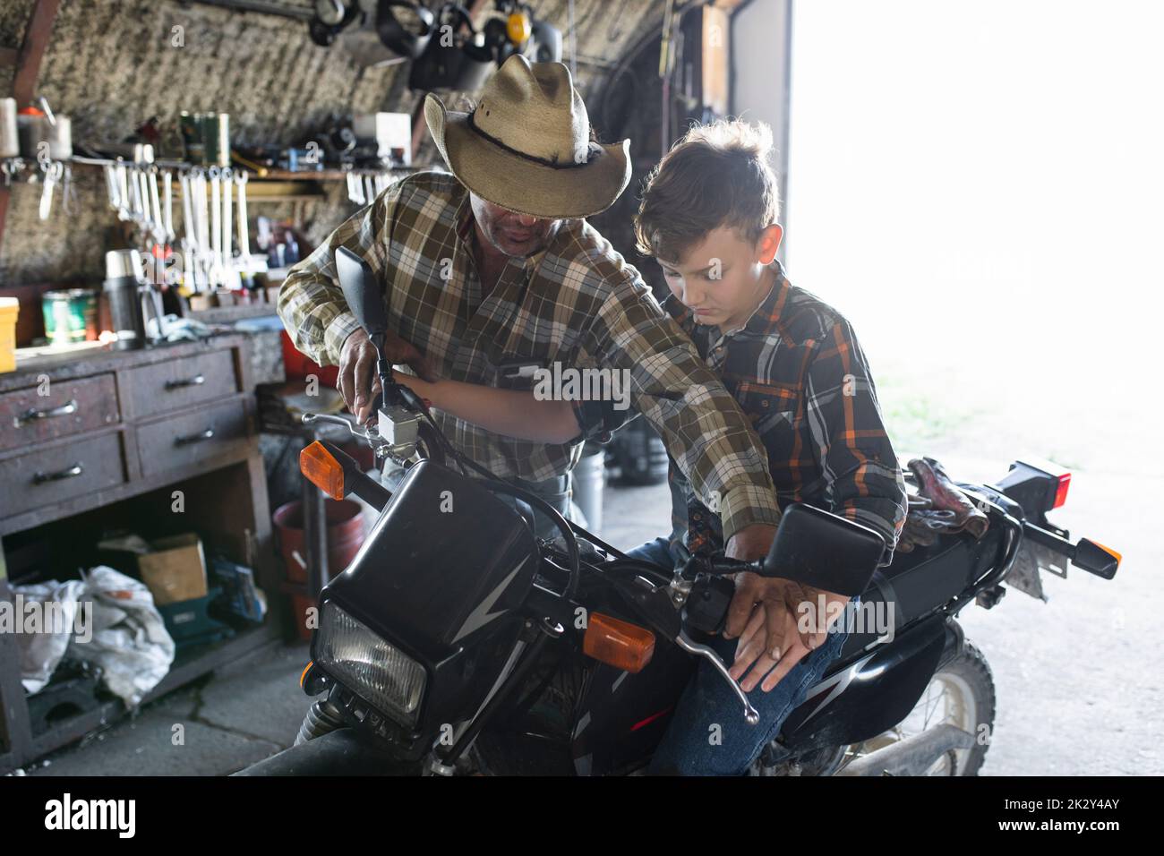 Child learning to drive motorcycle hi-res stock photography and images ...
