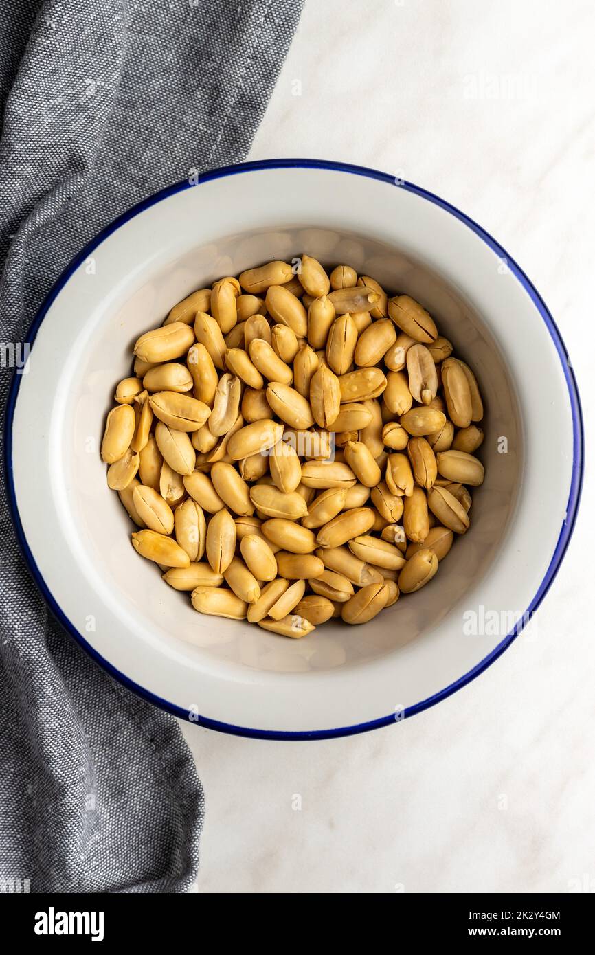 Roasted peeled peanuts in bowl Stock Photo - Alamy