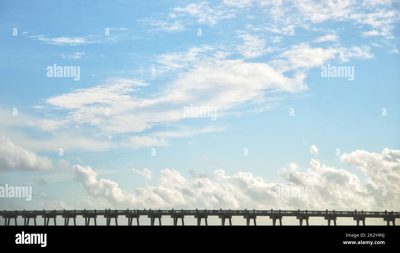 A bridge under the blue sky and white clouds Stock Photo - Alamy