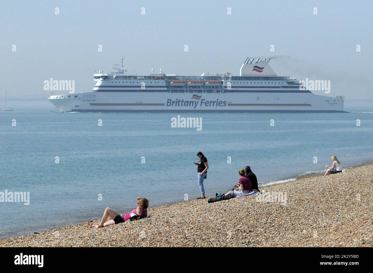 A cross channel ferry Cap Finistere passes by sunbathers enjoying the ...