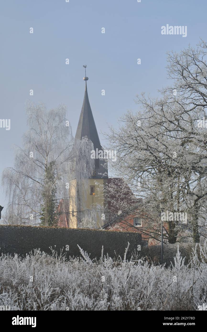 German church in a winter wonderland landscape with hoar frost on the ...