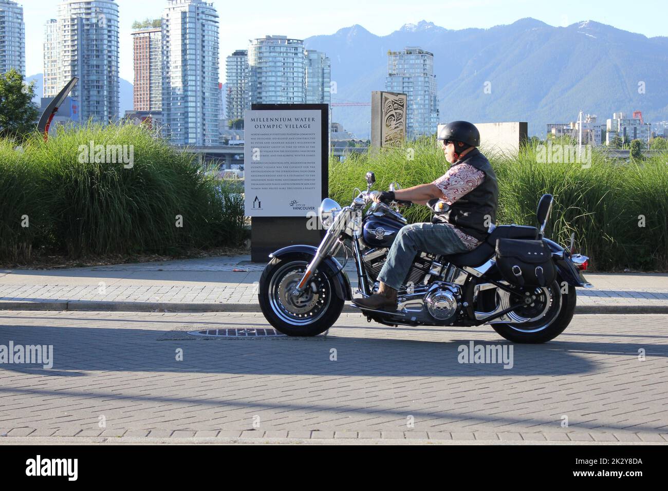 A man riding a classic motorcycle in Vancouver, British Columbia ...