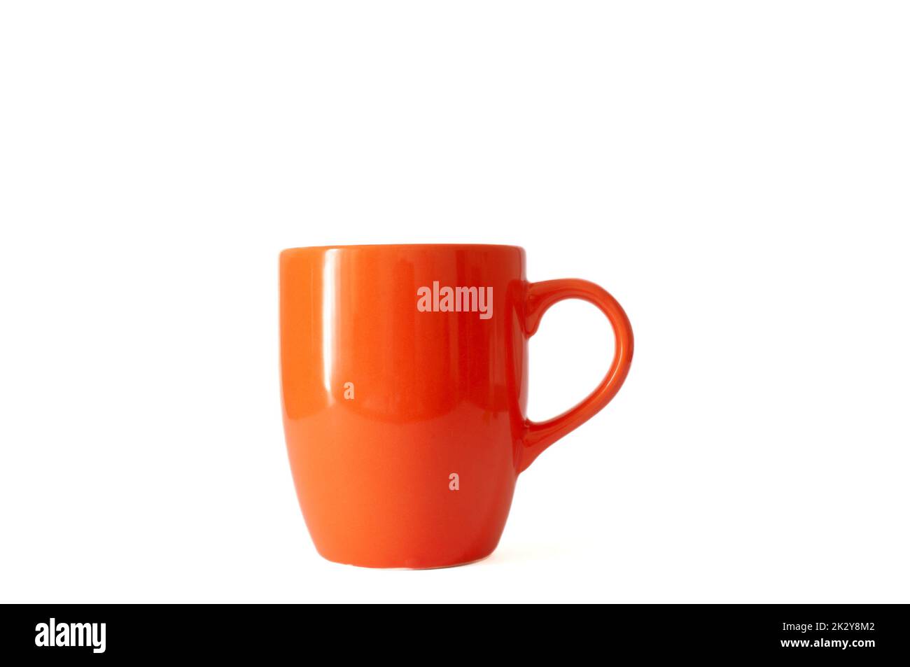 Shiny ceramic orange color tea cup or mug isolated on white background ...