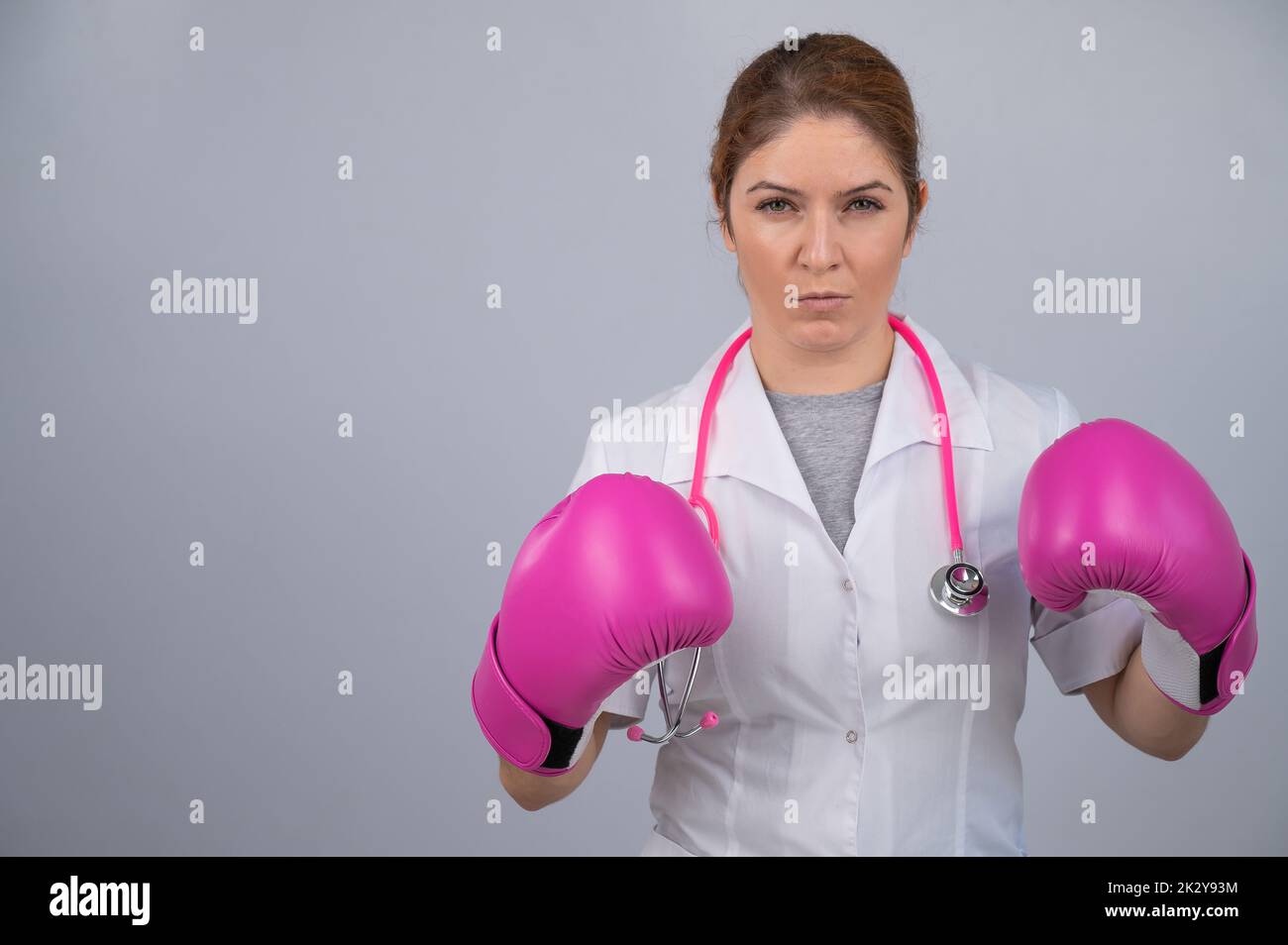 Woman doctor in pink boxing gloves on a white background Stock Photo ...
