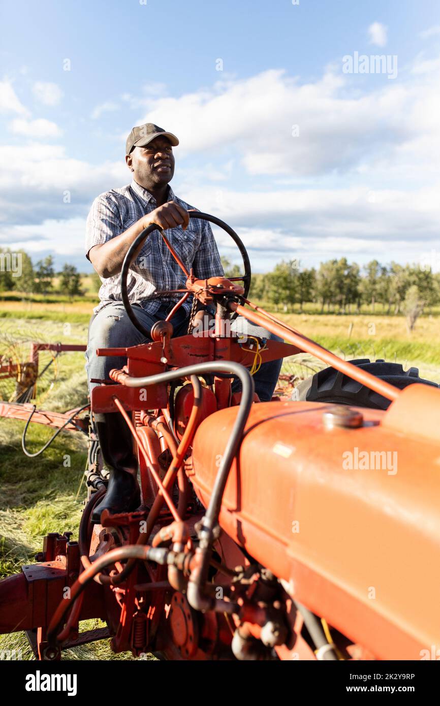 Black man driving tractor hi-res stock photography and images - Alamy