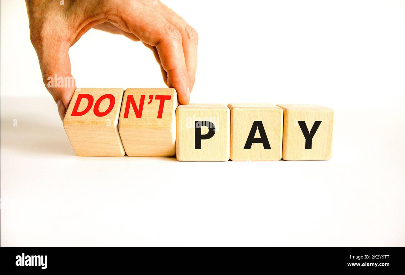 Do not pay symbol. Concept words do not pay on cubes. Businessman hand ...