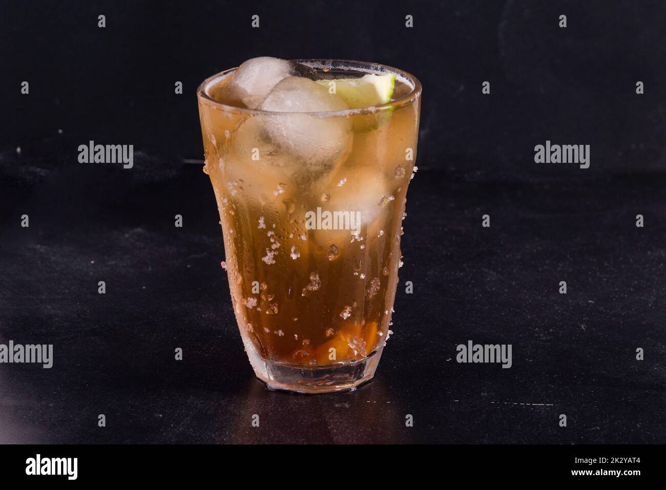 Rum cola cocktail on dark background Stock Photo - Alamy